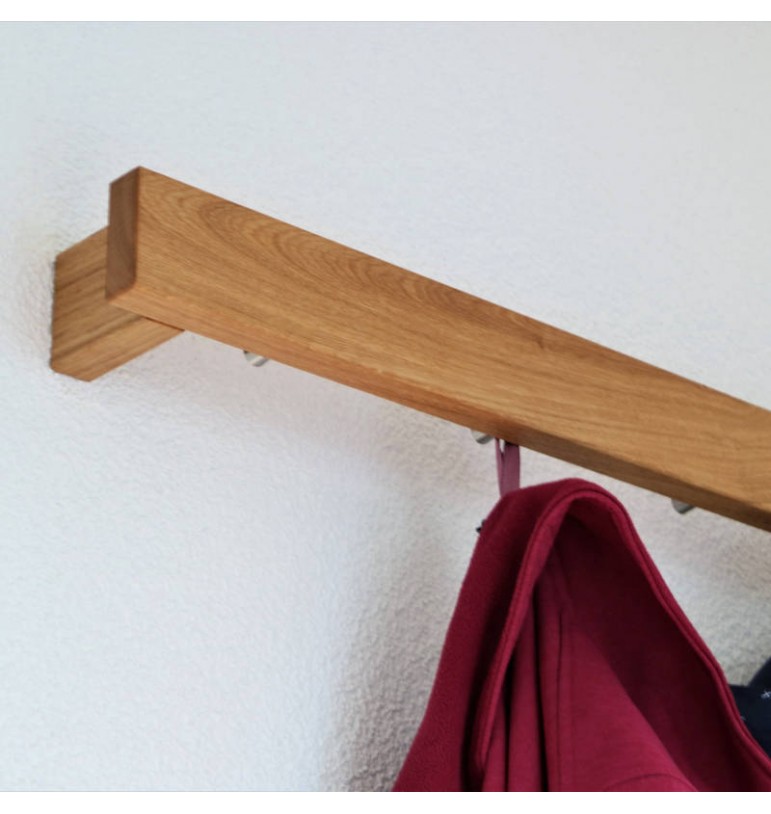 Minimalist wall-mounted coat rack in solid oak